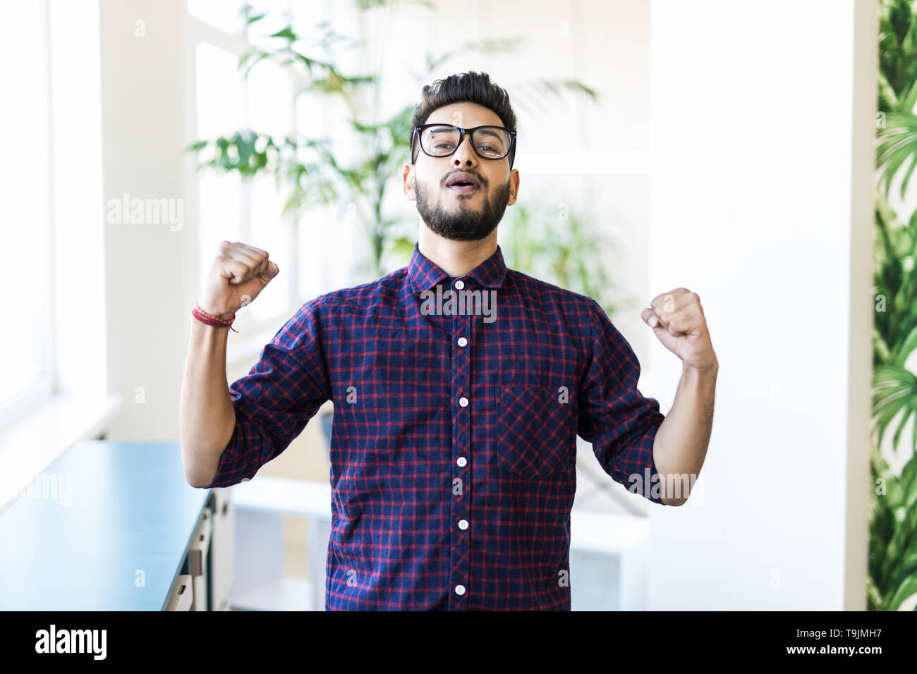 Man celebrating his success, modern office background Stock Photo - Alamy