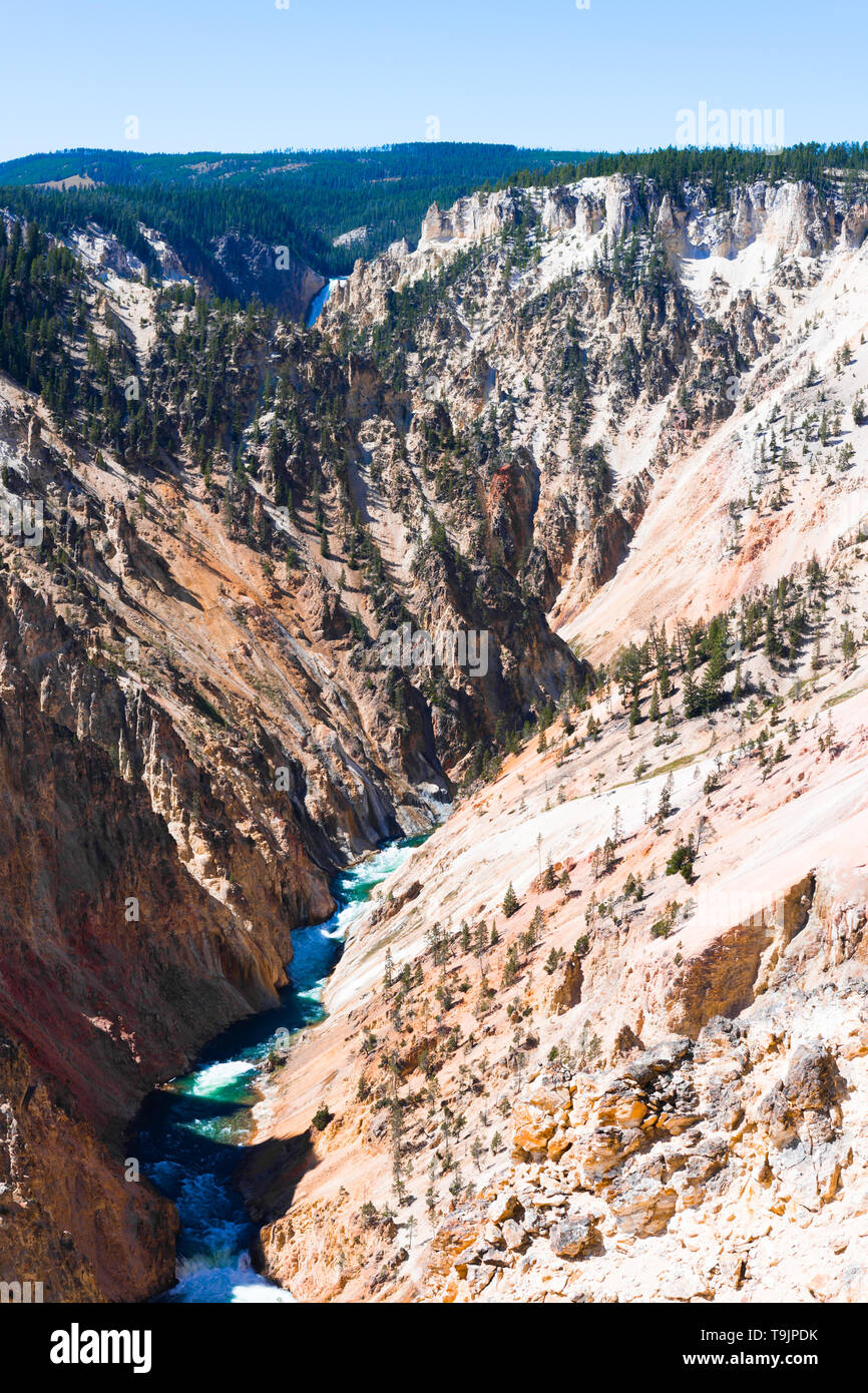 Steep canyon walls with emerald river running down the middle ...