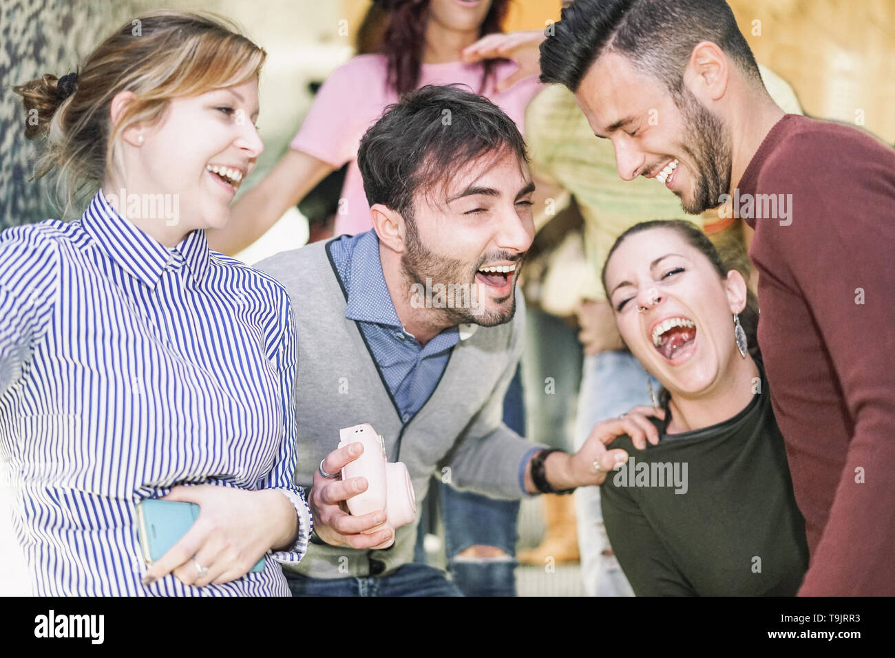 Group of friends laughing together in underground metropolitan station ...