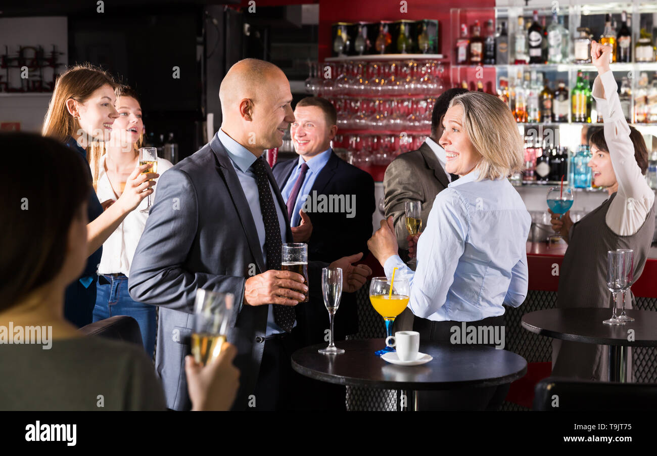 Jolly man and woman drinking alcohol and having conversation on ...