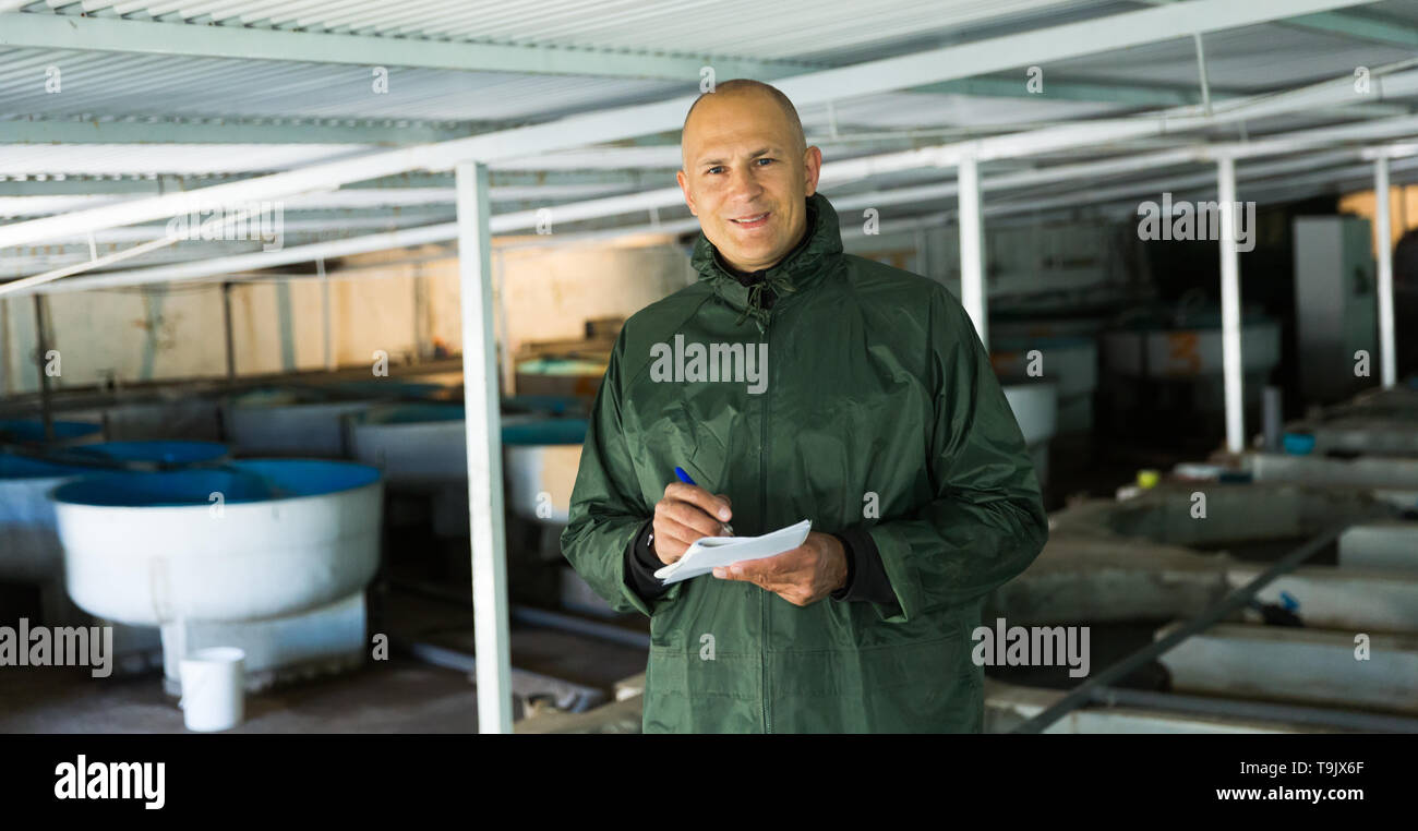 Portrait of man fish farm worker at trout breeding incubator Stock ...