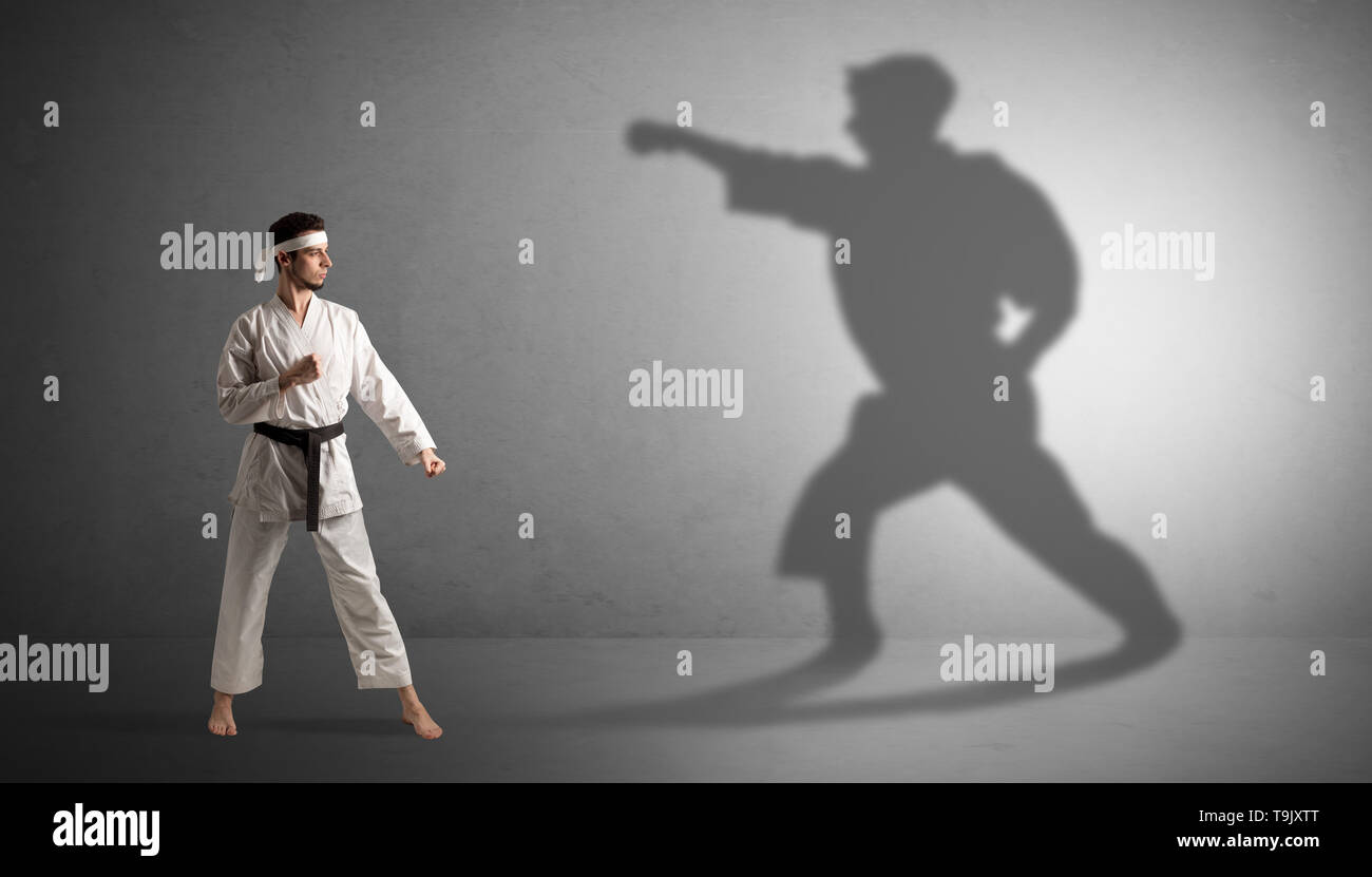 Young karate man confronting with his own shadow Stock Photo - Alamy