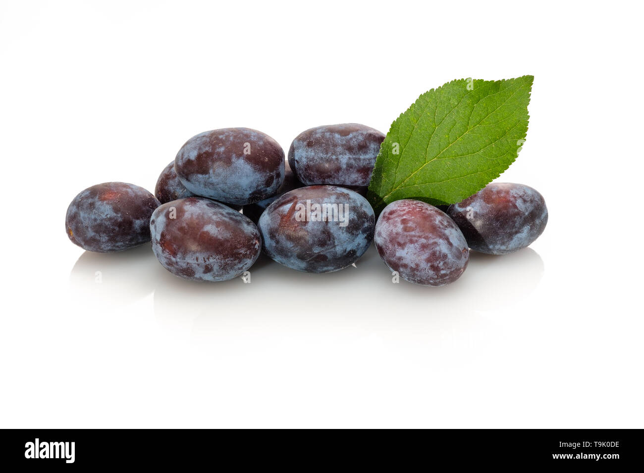 Plums fruit raw with green leaf white isolated Stock Photo - Alamy