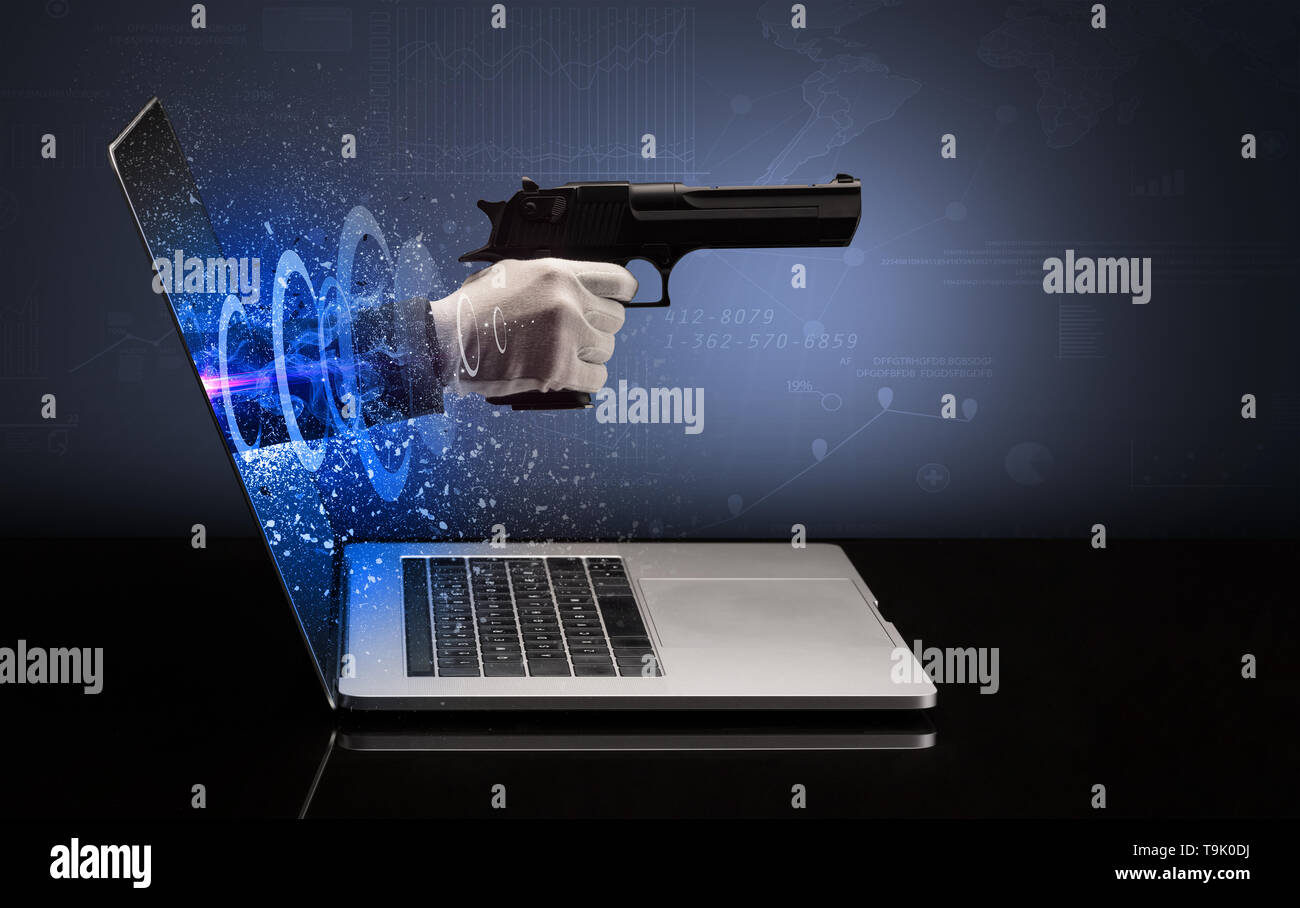 Hand with gun coming out of a laptop with sparkling effects Stock Photo ...