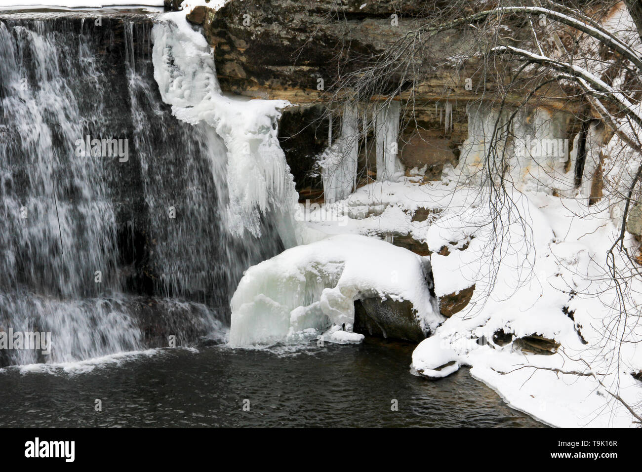 Snow and ice cover a frozen winter waterfall Stock Photo - Alamy