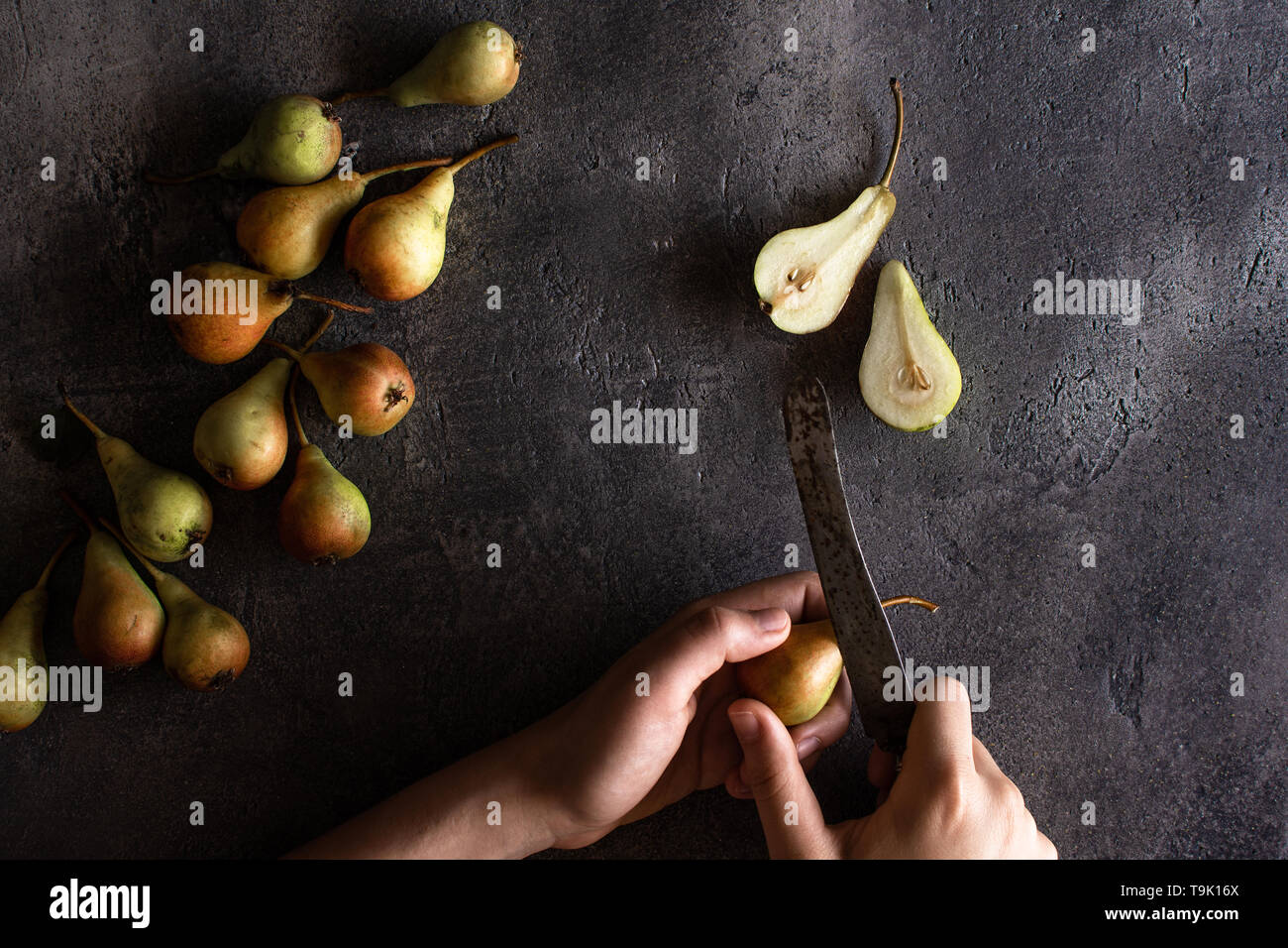 Hands Cutting Pears on Rustic Dark Background with Copy Space ...