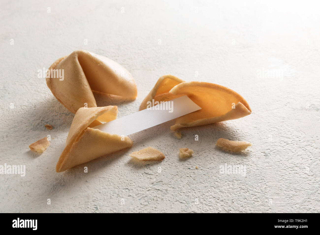chinese fortune cookies, one is cracked with blank paper slip for the ...