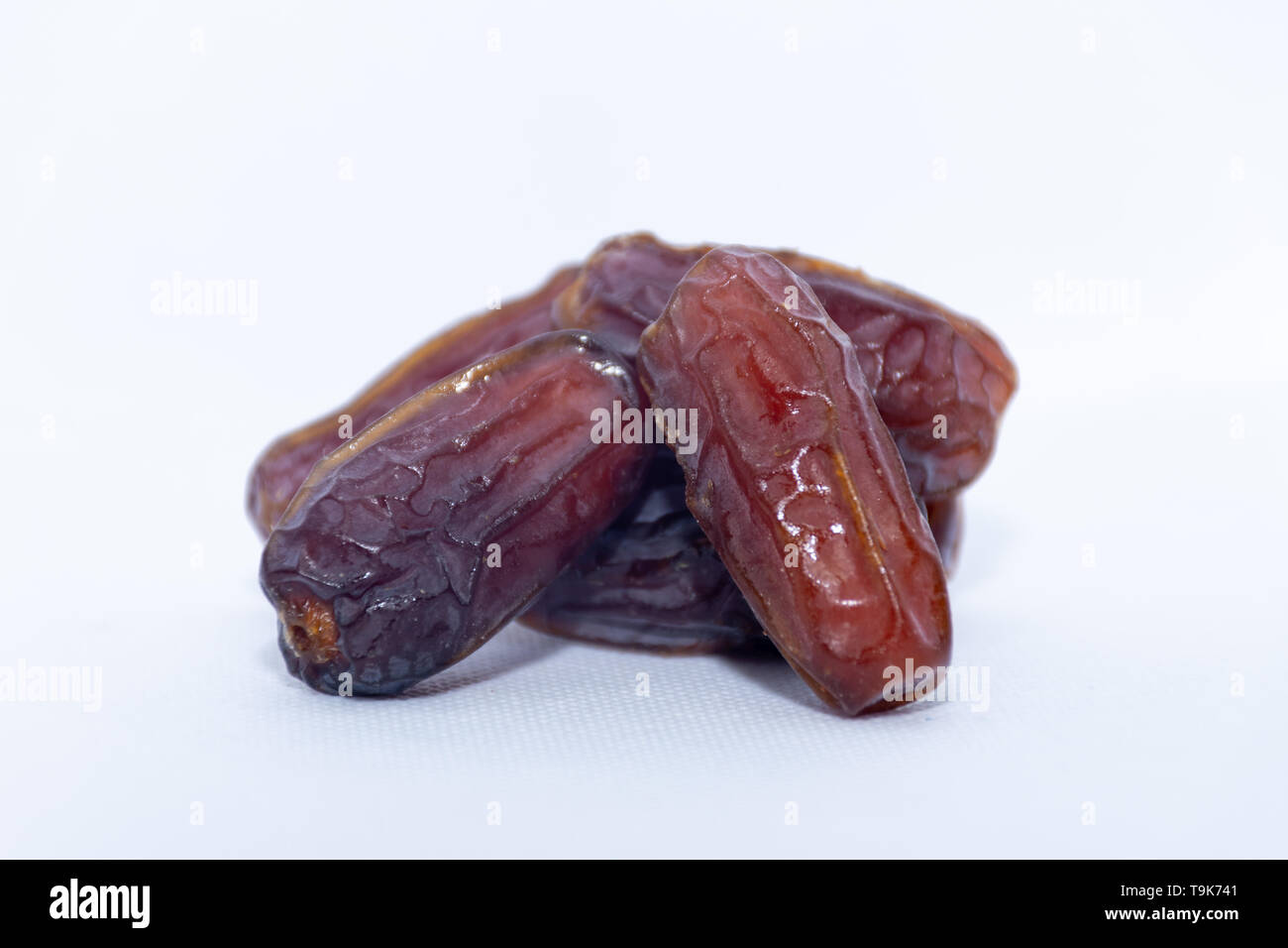 A group of medjool dates from Saudi Arabia on an isolated white ...
