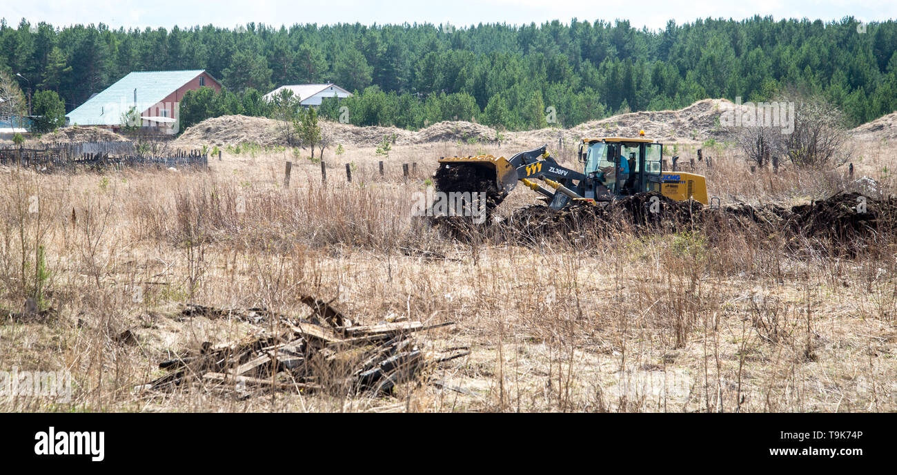 Chelyabinsk region, Russia - May 2019: bulldozer pushes the ground ...