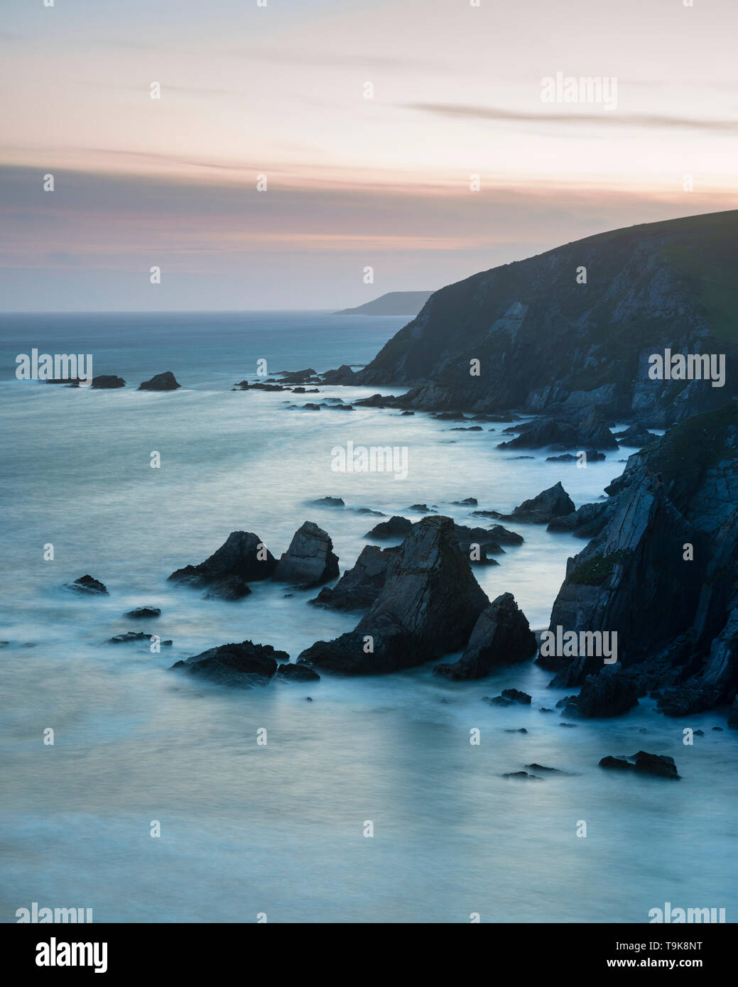 Beautiful sunset landscape image of Westcombe Beach in Devon England ...