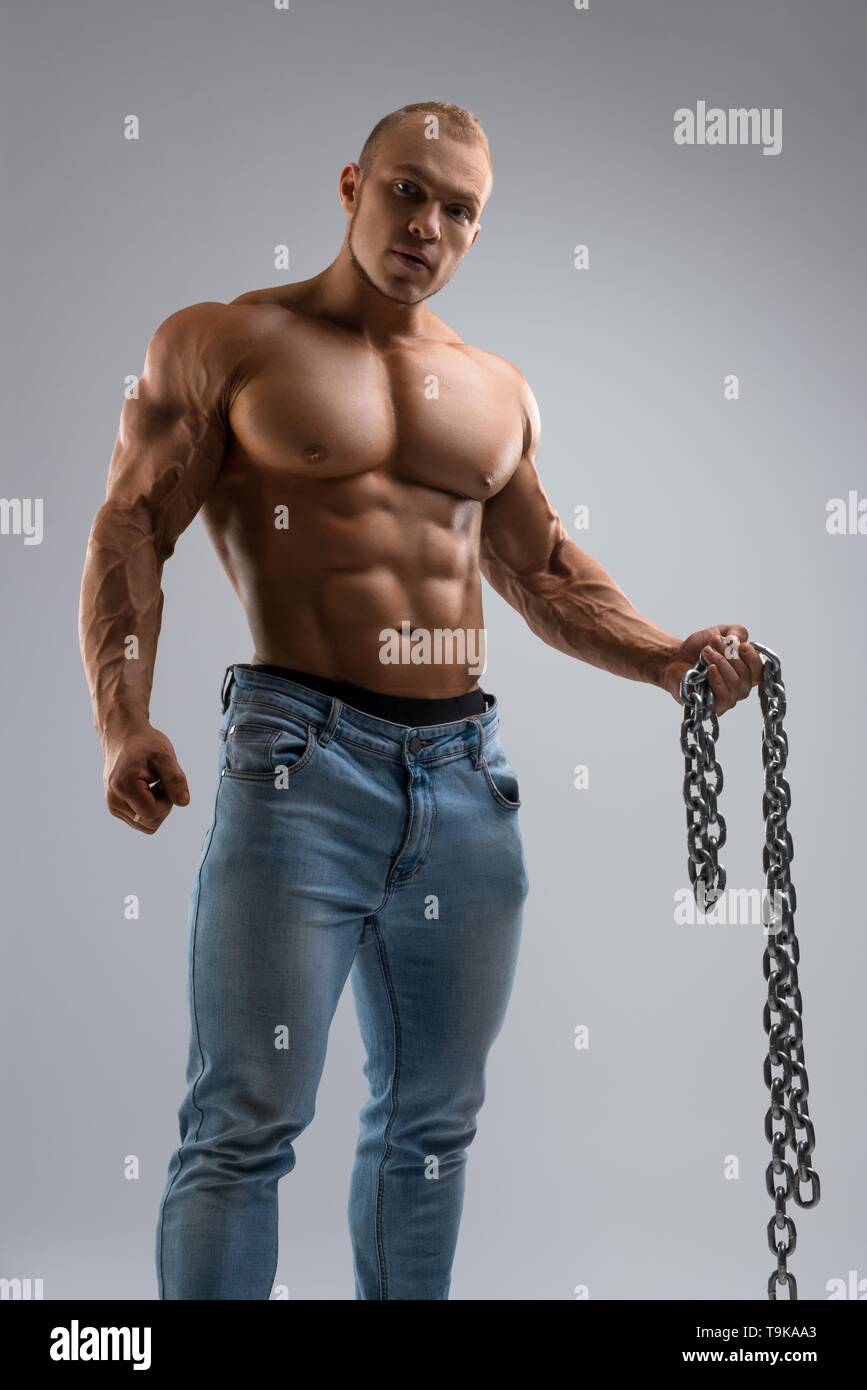Strong guy with chain looking at camera Stock Photo - Alamy