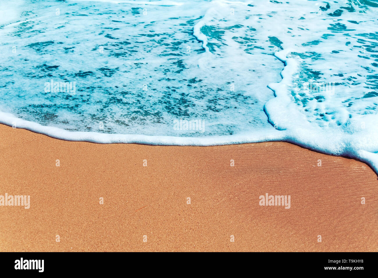 Sea wave on beach sand Stock Photo - Alamy