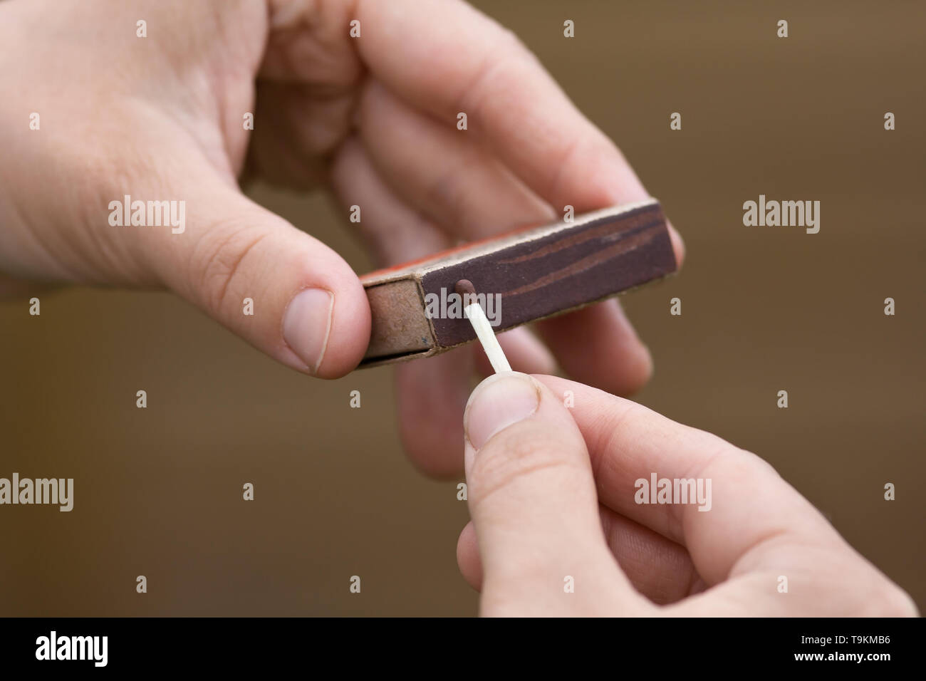 hands striking a match on blurred background, closeup Stock Photo - Alamy