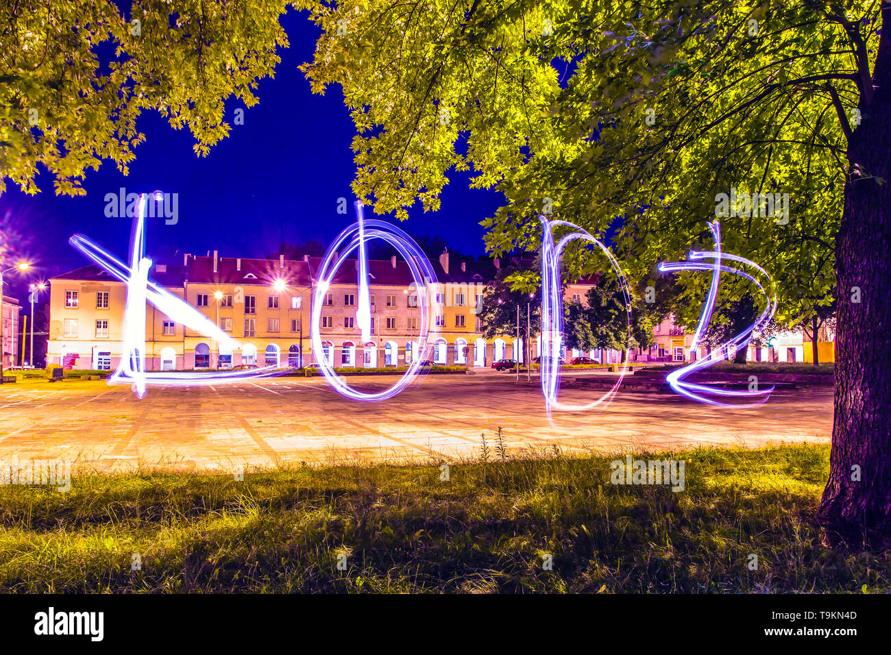 City of Lodz name drawn using light painting technique at night in old ...