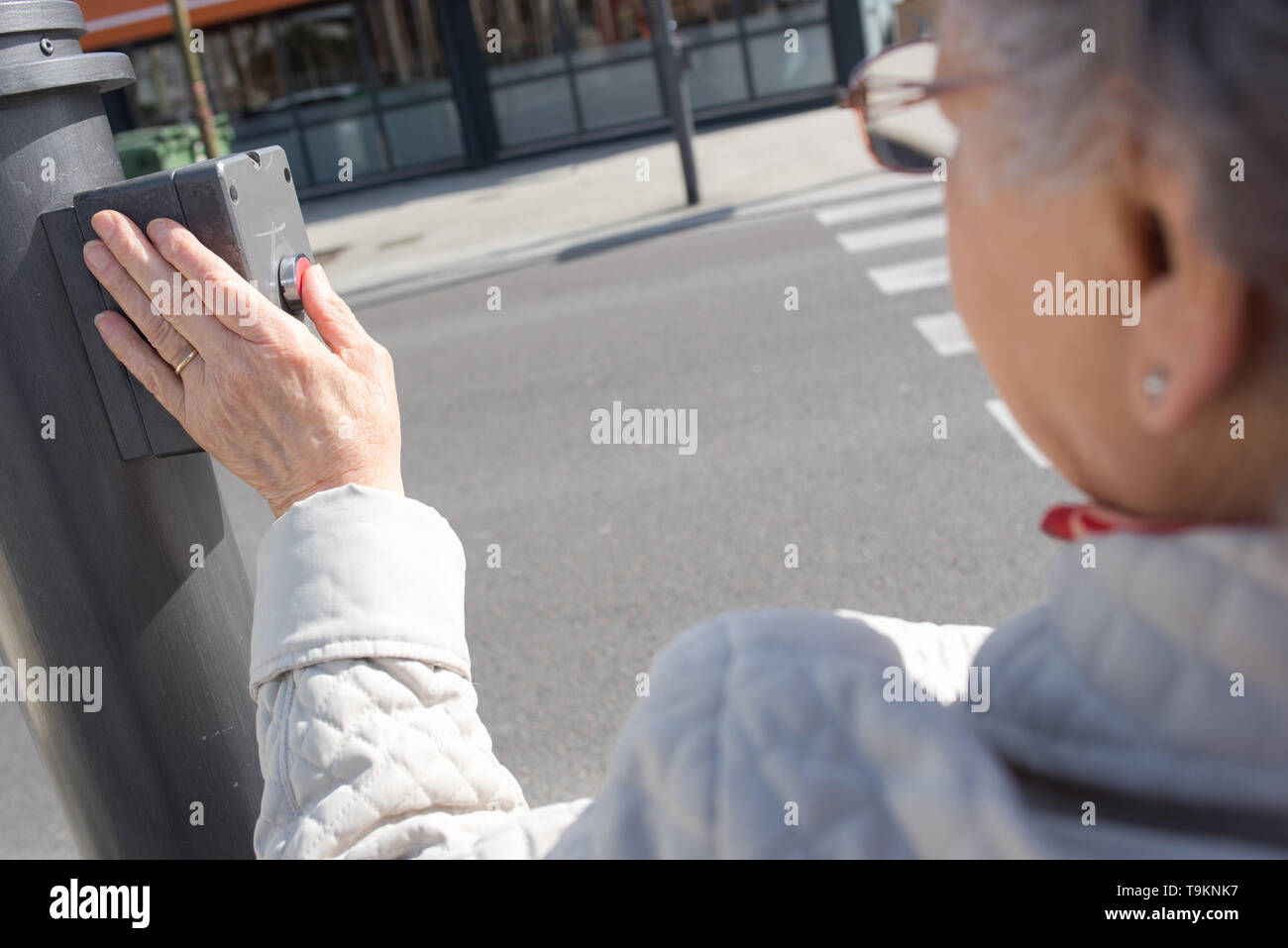 elderly person in a wheelchair crossing road Stock Photo - Alamy