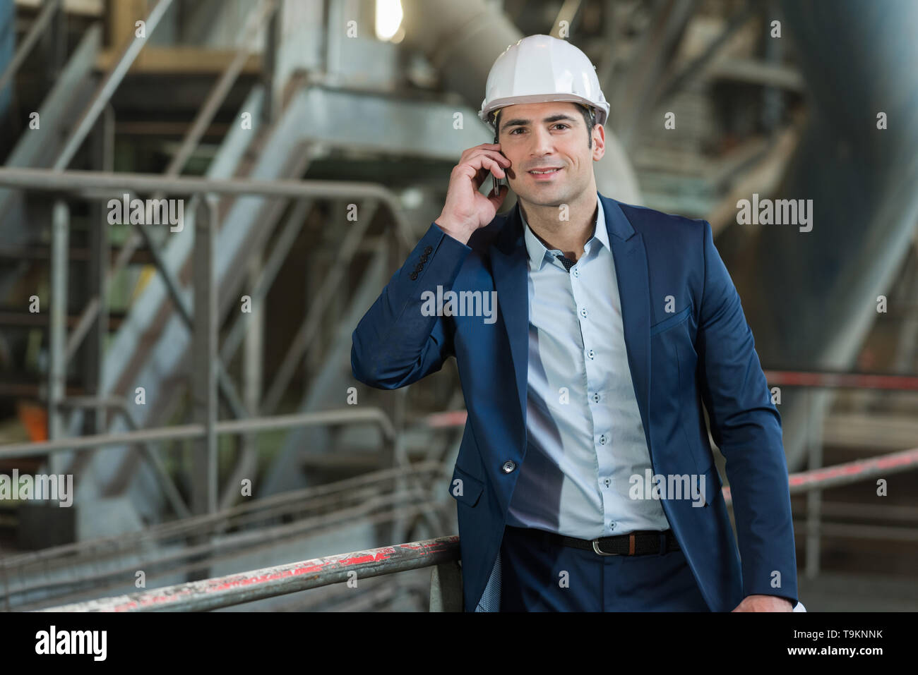 man in hardhat and suit making a call Stock Photo - Alamy