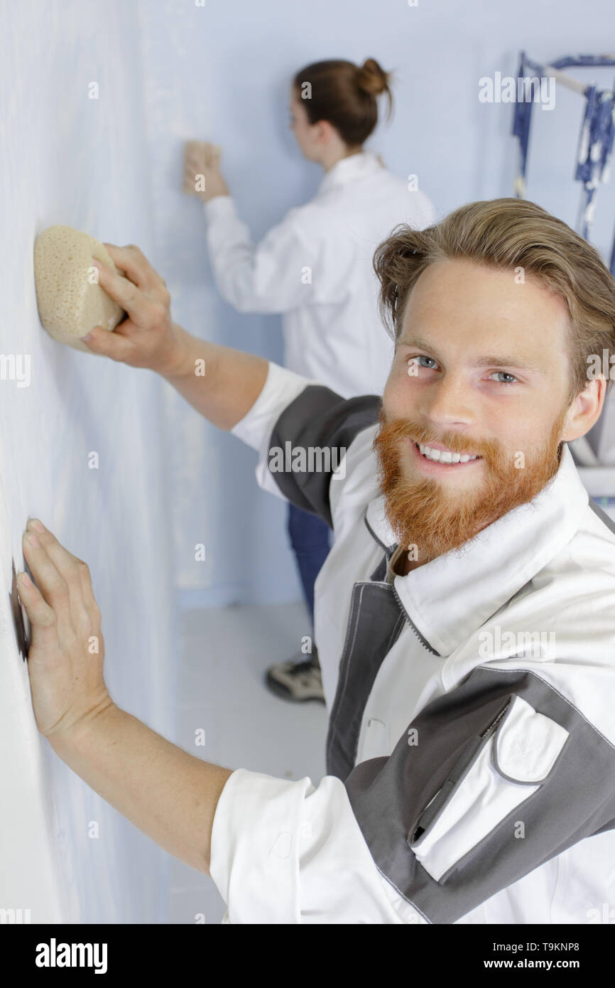 professional man using sponge float on wall Stock Photo - Alamy