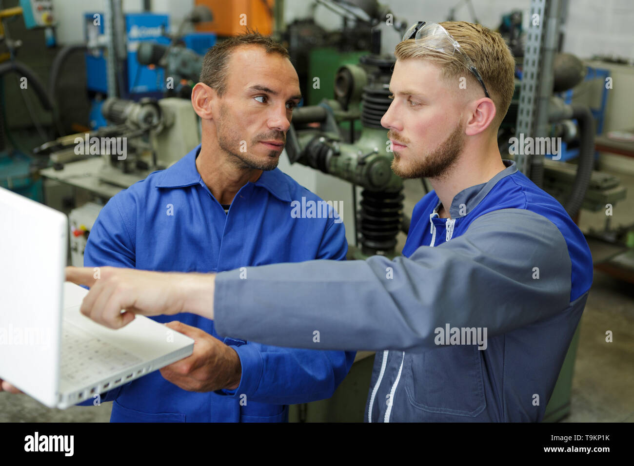 Mechanic looking service information hi-res stock photography and ...