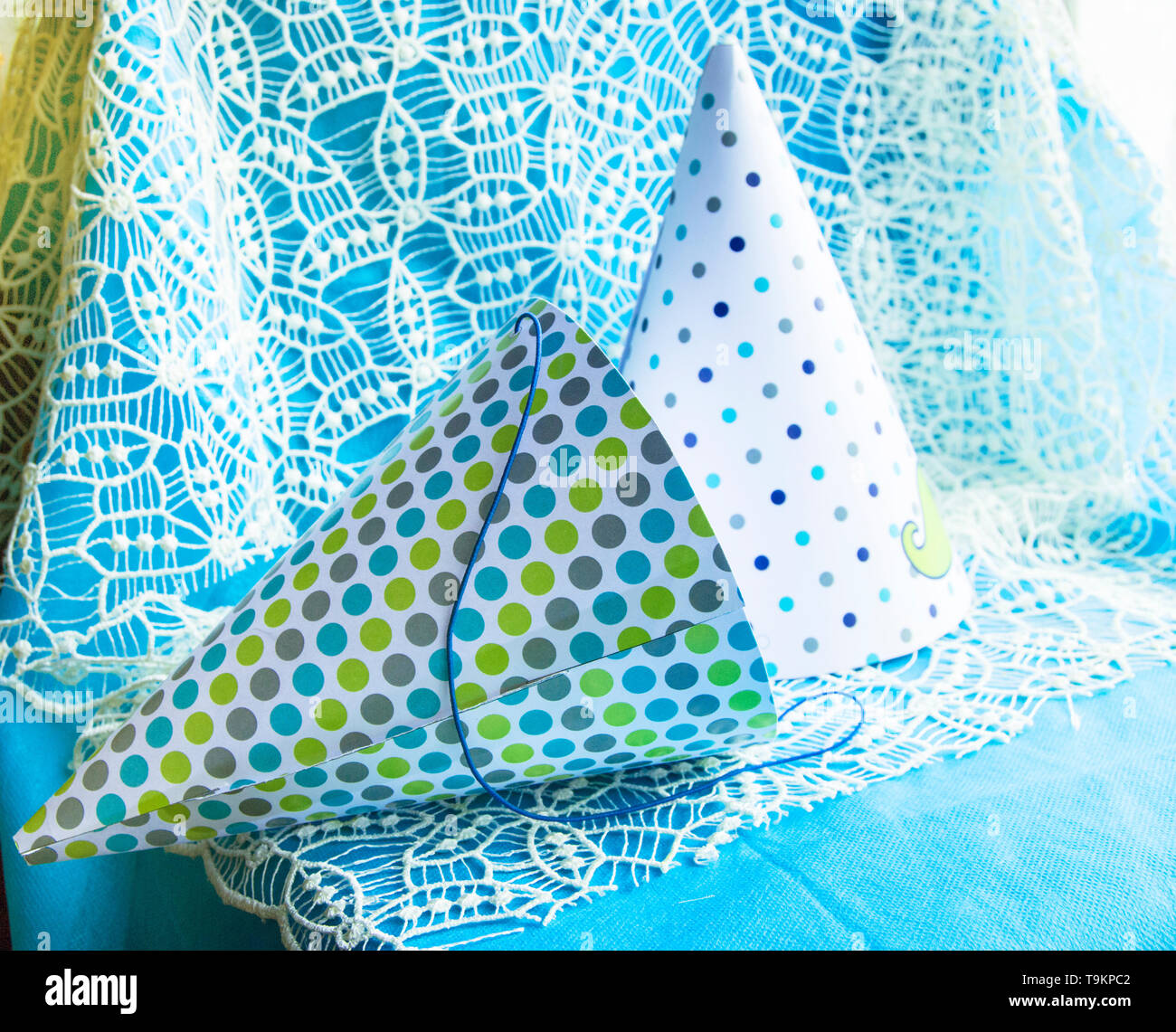 Festive caps on a blue napkin with lace embroidery, a copy of the space ...