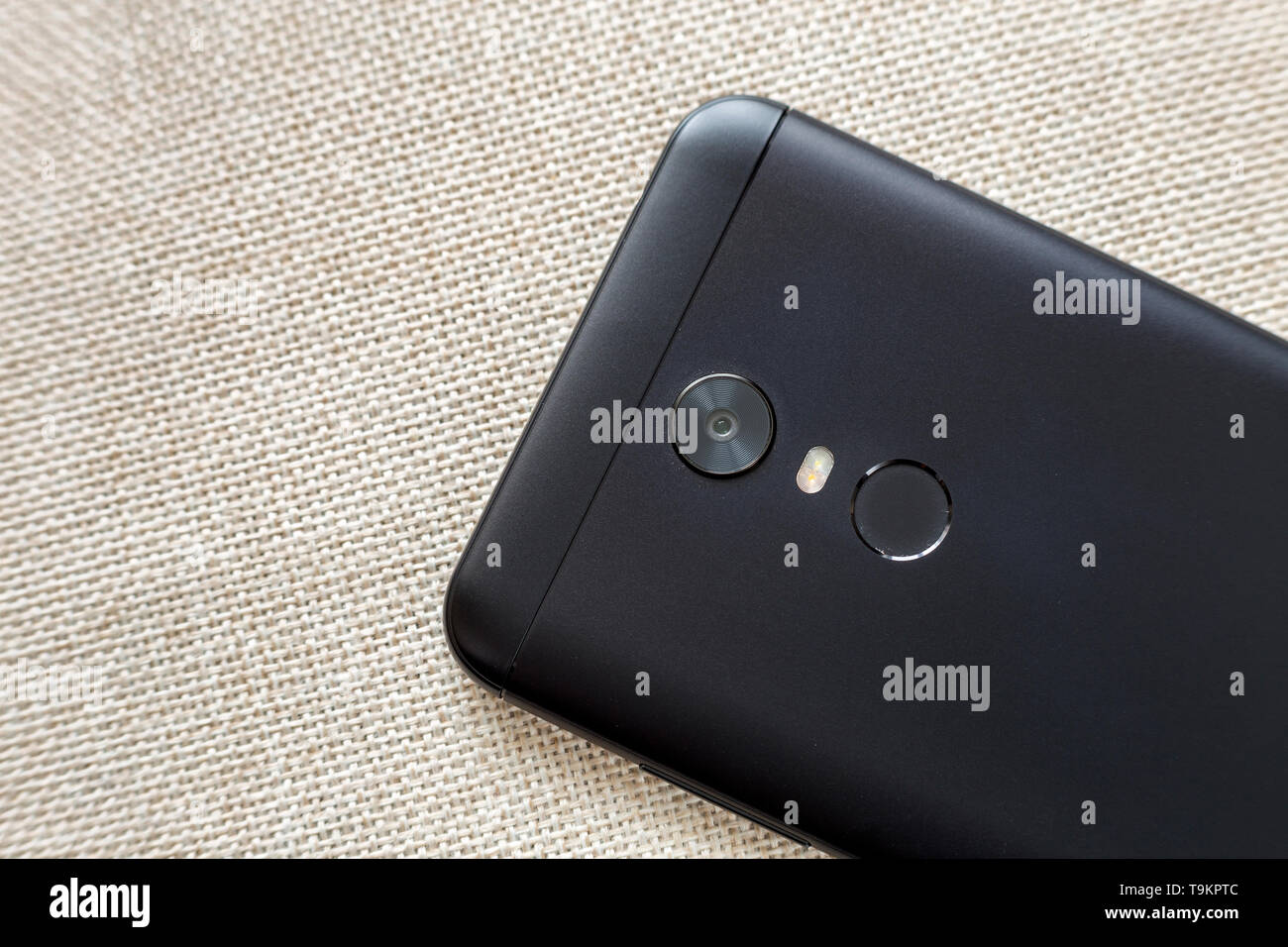 Back side of black cellphone isolated with security thumb fingerprint ...