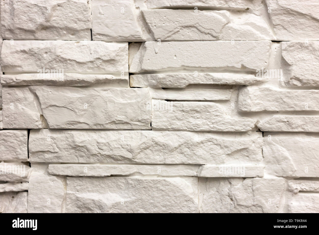 Close-up of white solid limestone wall or stone fence. Abstract copy ...