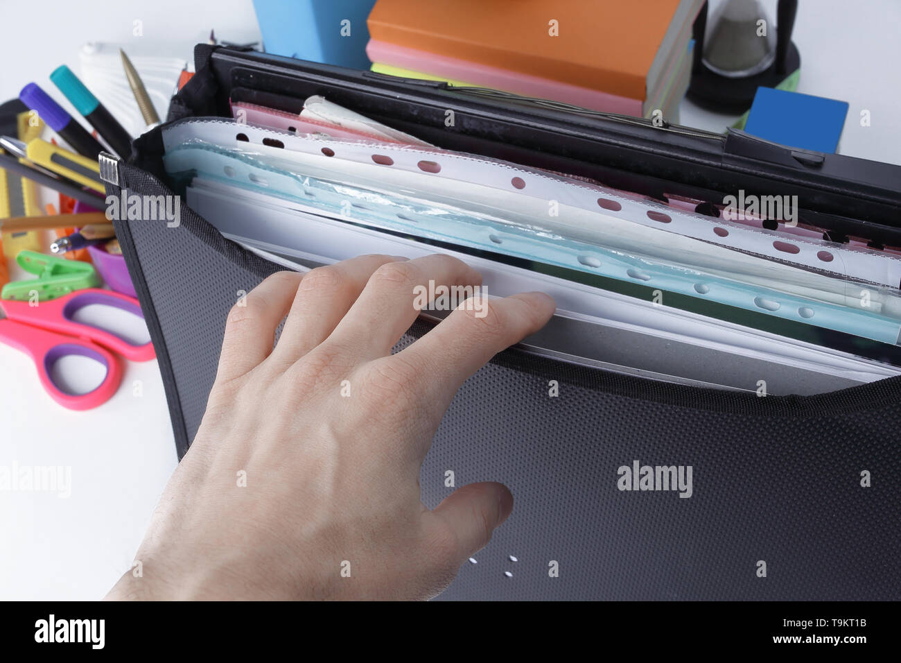 close up. briefcase with file folders and school supplies on white ...