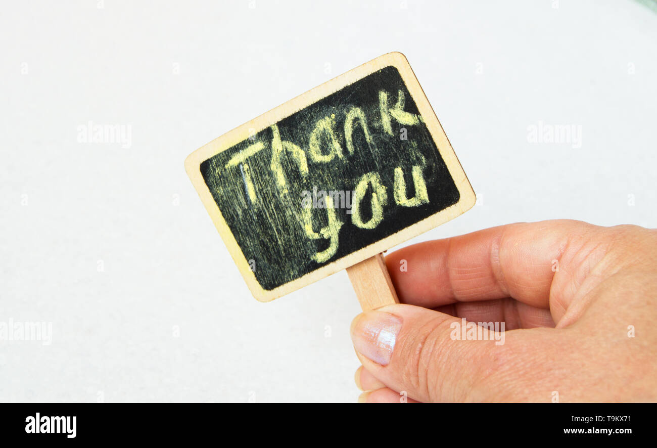 Female hand with a sign in his hands with the words thank You Stock ...