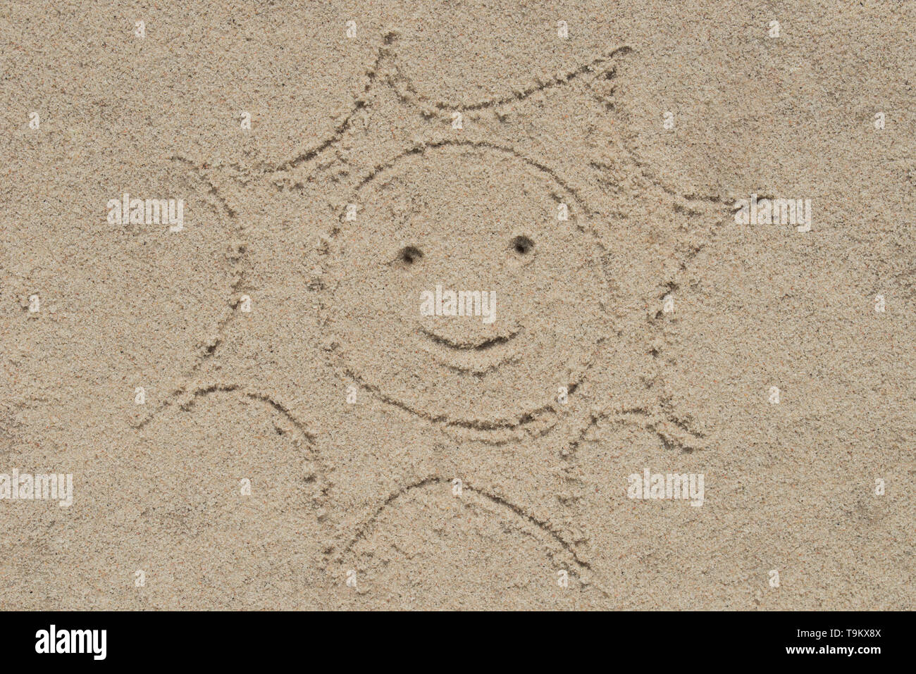 smiling sun on sand drawing closeup Stock Photo - Alamy