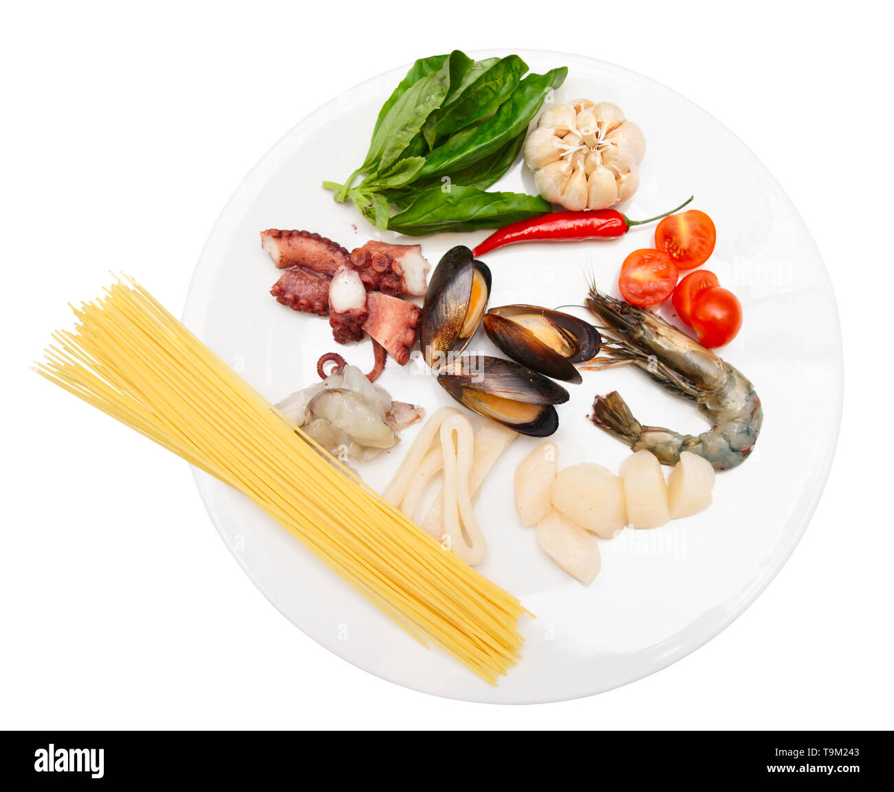 Set of ingredients for seafood based pasta on plate isolated on white ...