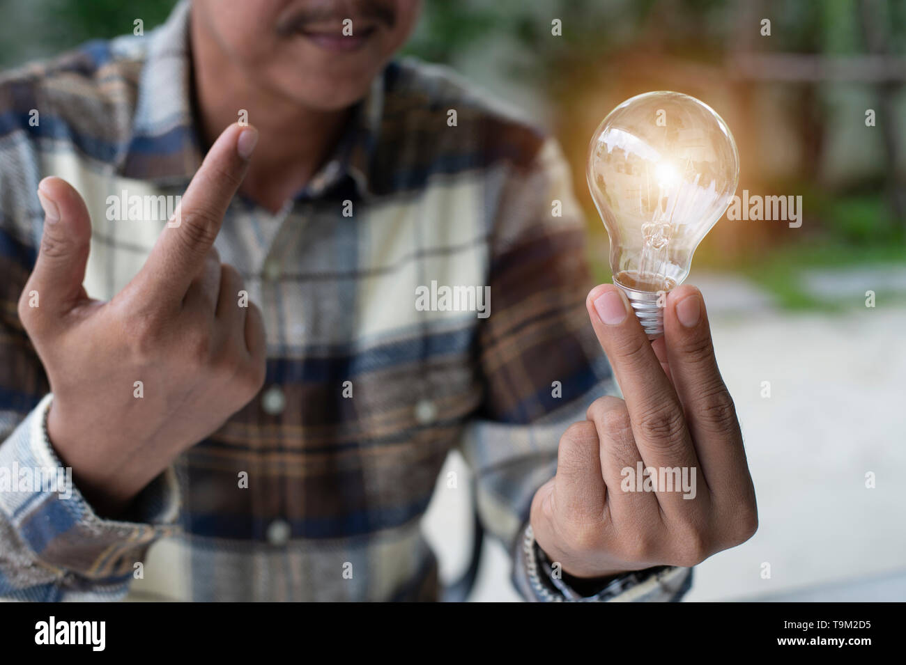 A hand holding is light bulb, Creative ideas concept, lightbulb for new ...