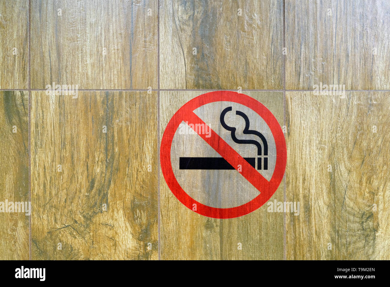 On the wall is a Smoking ban sign in the toilet Stock Photo - Alamy