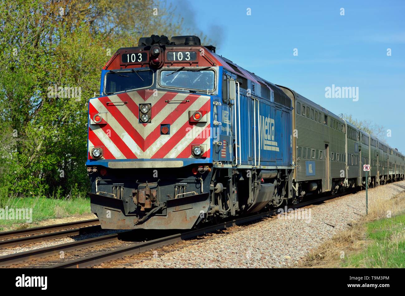 Bartlett, Illinois, USA. A Metra locomotive trailing a commuter train ...