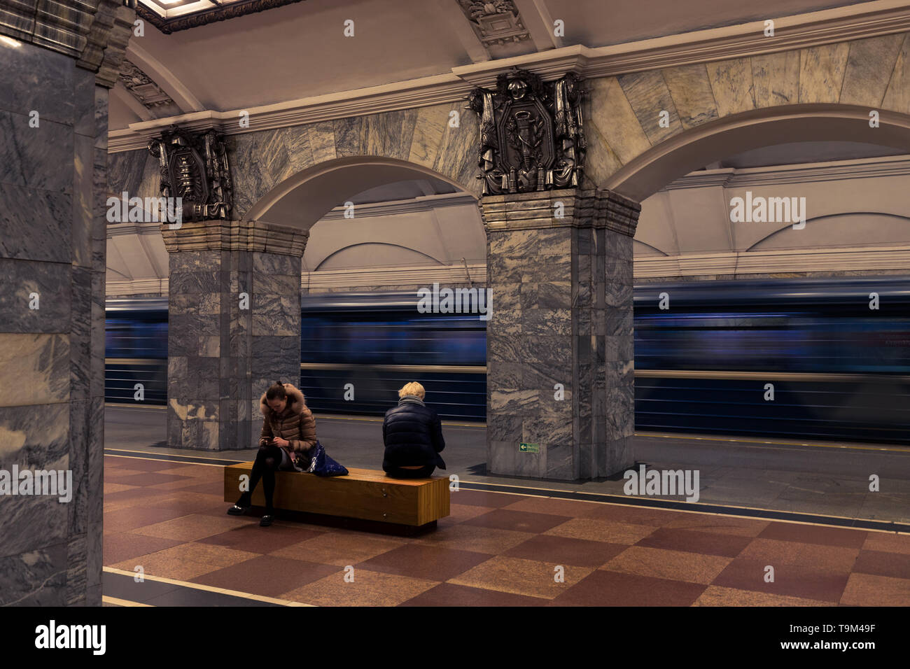 Lone traveller reading a book while waiting the subway in Kirovsky ...