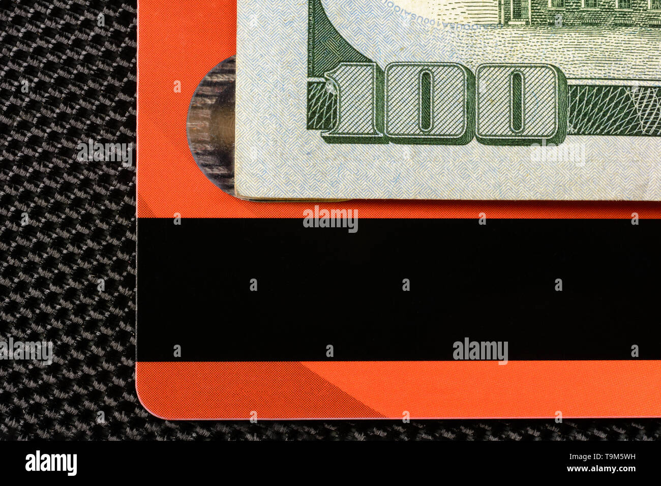 Credit card is reverse side with a black ribbon, one hundred dollars on ...