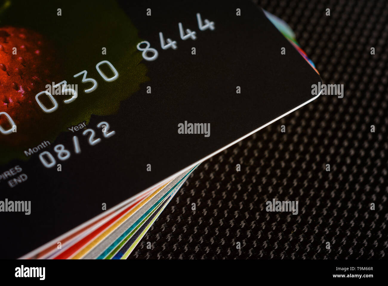 Credit cards are displayed by a fan on a black background. 2019 Stock ...