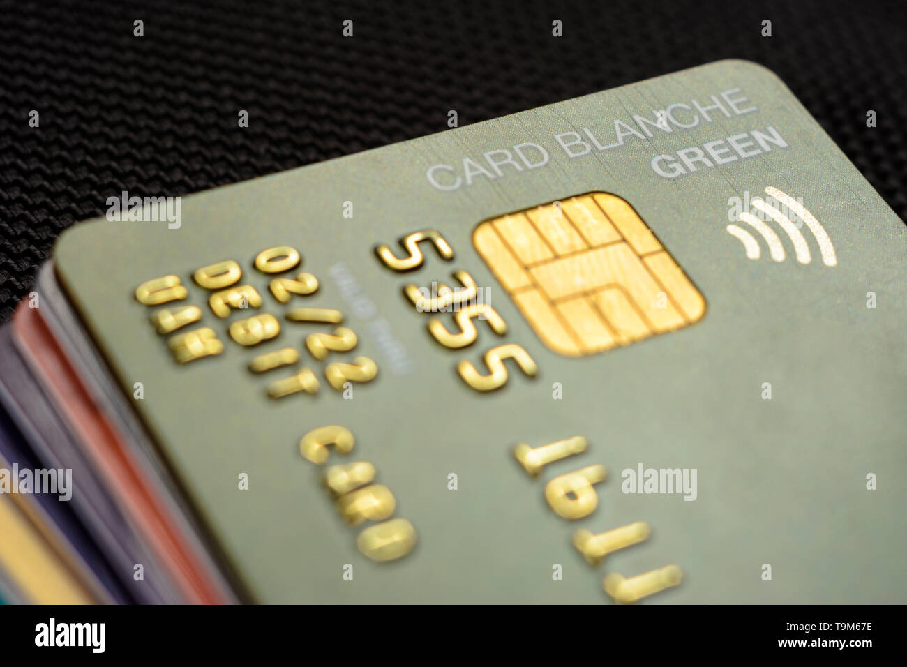 Close-up credit card where the chip is clearly visible on a black ...