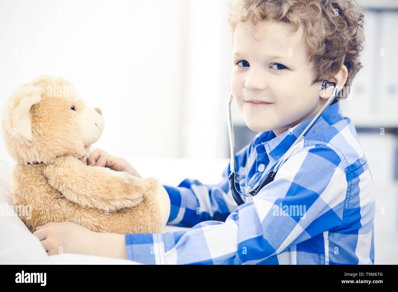 Doctor and patient child. Physician examining little boy. Regular ...