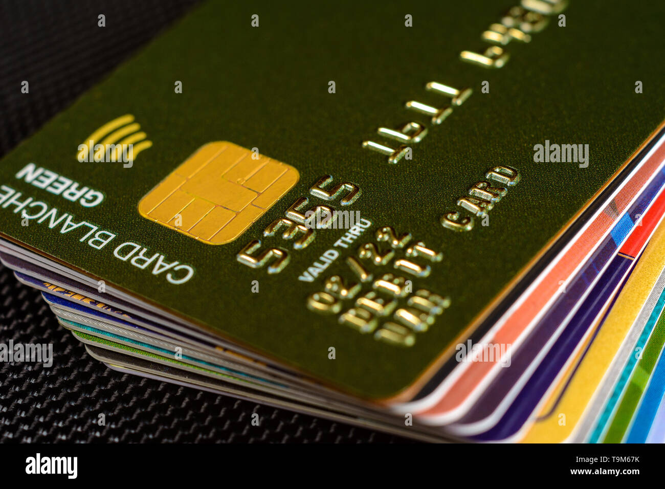 Close-up credit card where the chip is clearly visible on a black ...