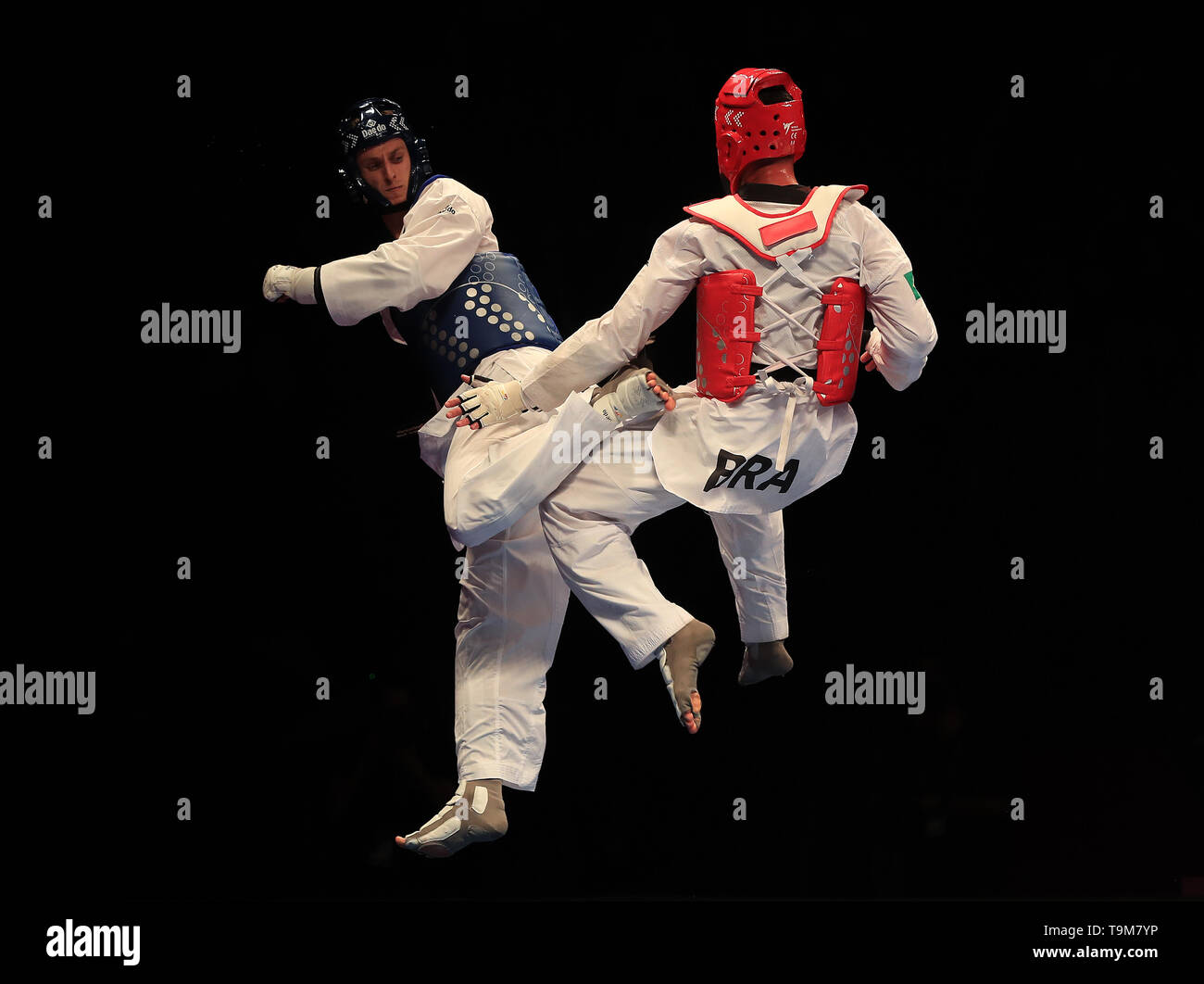 Russia's Vladislav Larin (blue) competes against Brazil's Icaro Miguel ...