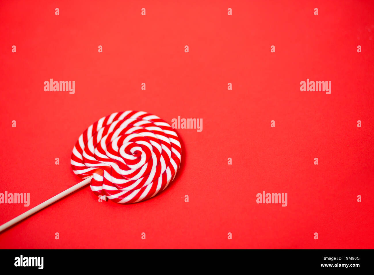 Sweet round lollipop. Striped lollipop on coral background. Red and ...