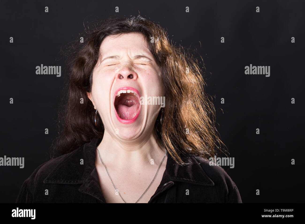 Negative emotions concept - Scared screaming young woman standing over ...