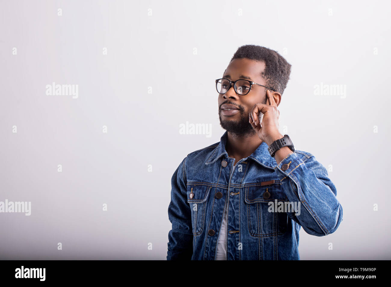Thoughtful clever handsome african man student touching head with ...