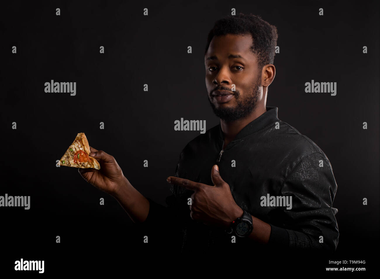 Handsome black man holding pizza hi-res stock photography and images ...
