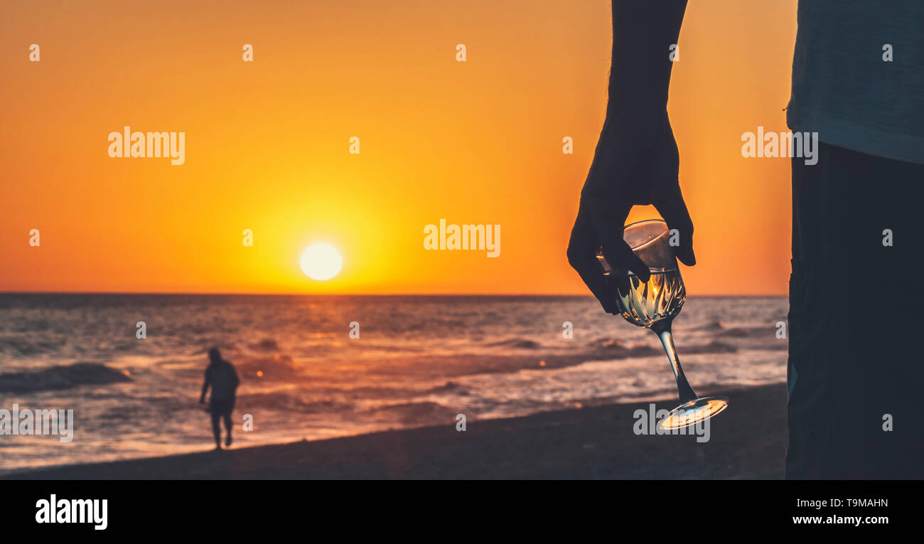 Man at sunset with glass on background setting sun. romantic date in ...