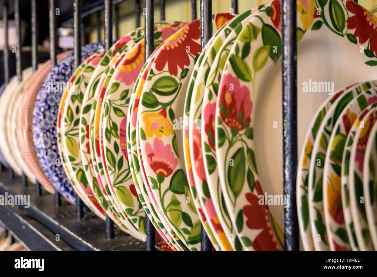 Dinner Plates Lined Up in plate rack in rustic kitchen Stock Photo - Alamy