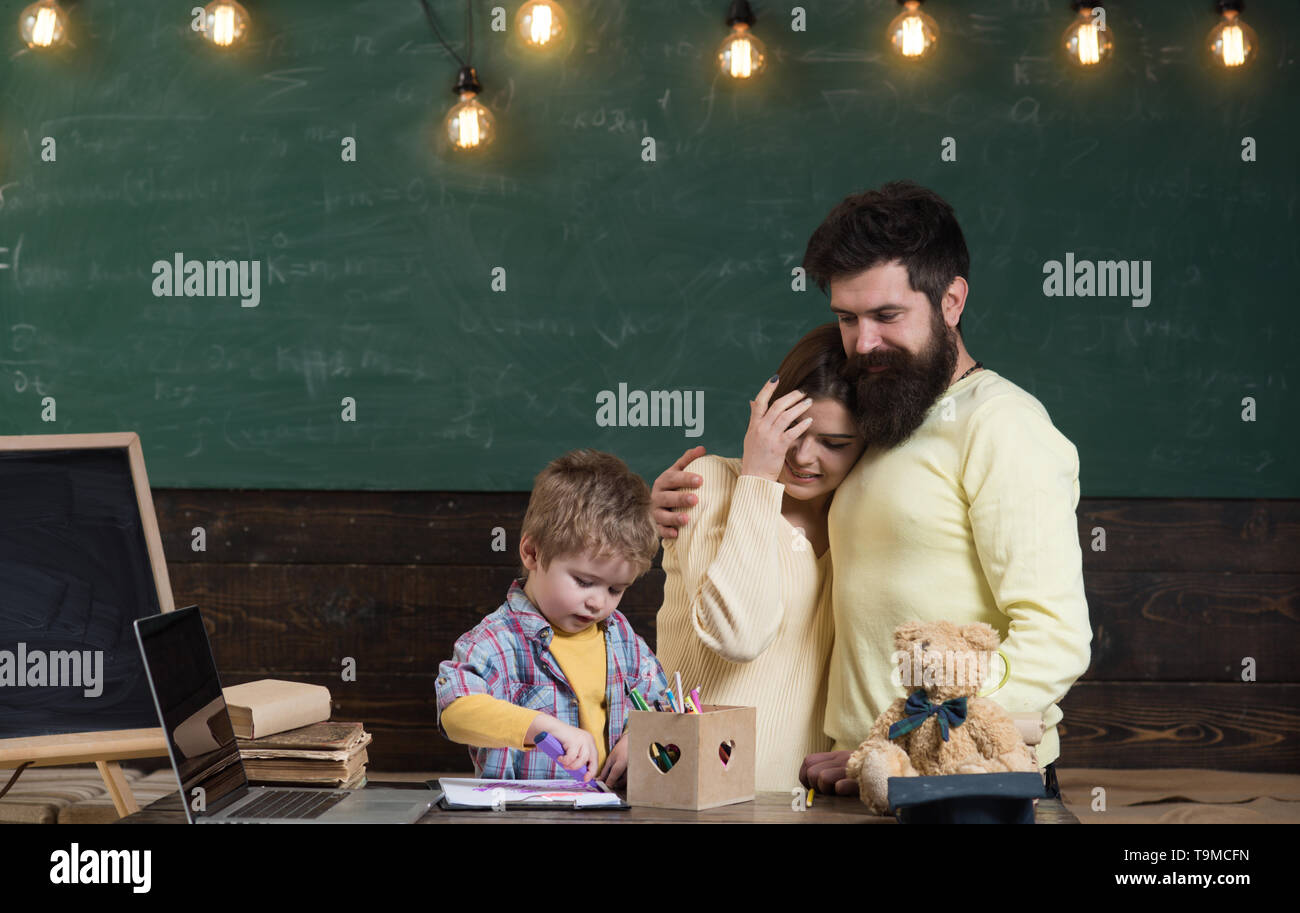 Parent support concept. Parents watching their son drawing, learning to ...