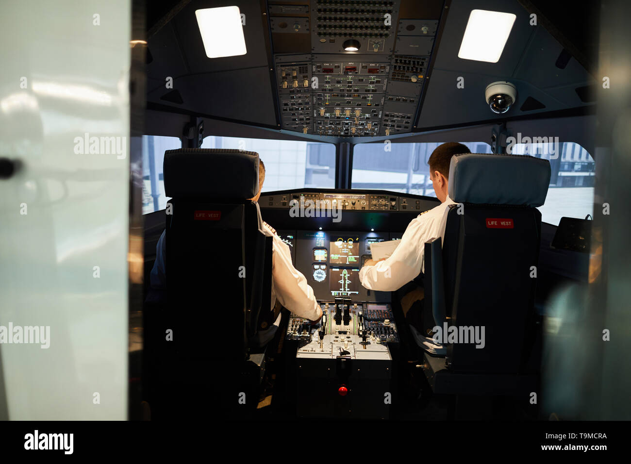 Pilots in airplane cockpit Stock Photo - Alamy