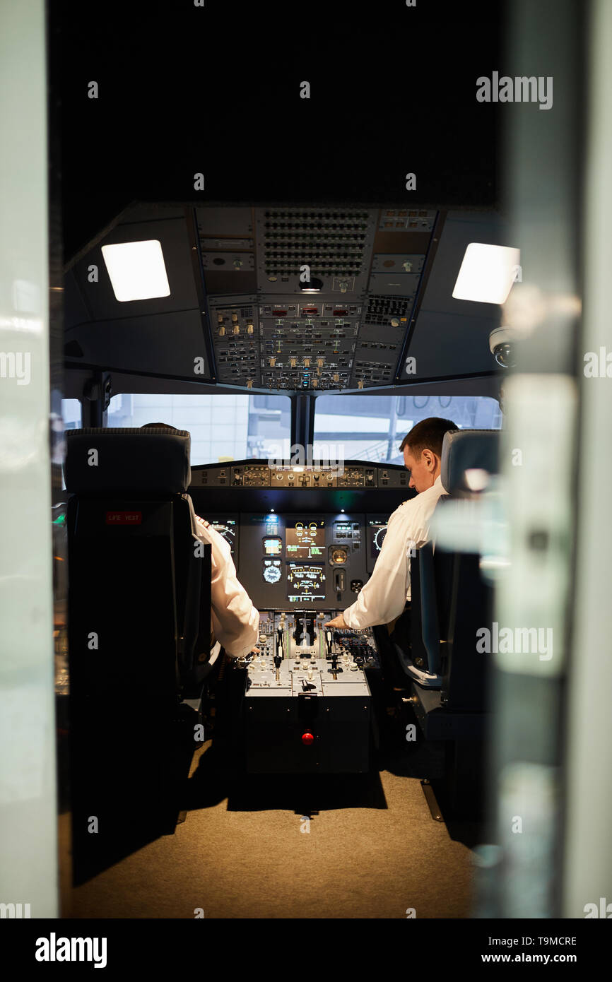 Pilots in cabin Stock Photo - Alamy
