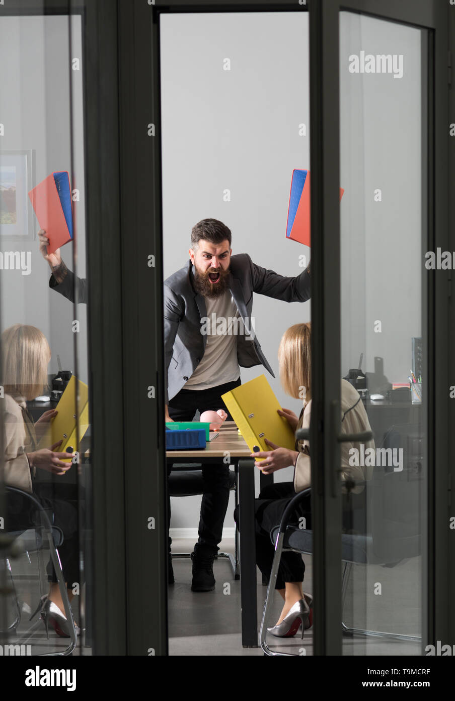 Mad crazy young businessman arguing with sad stressed businesswoman at ...