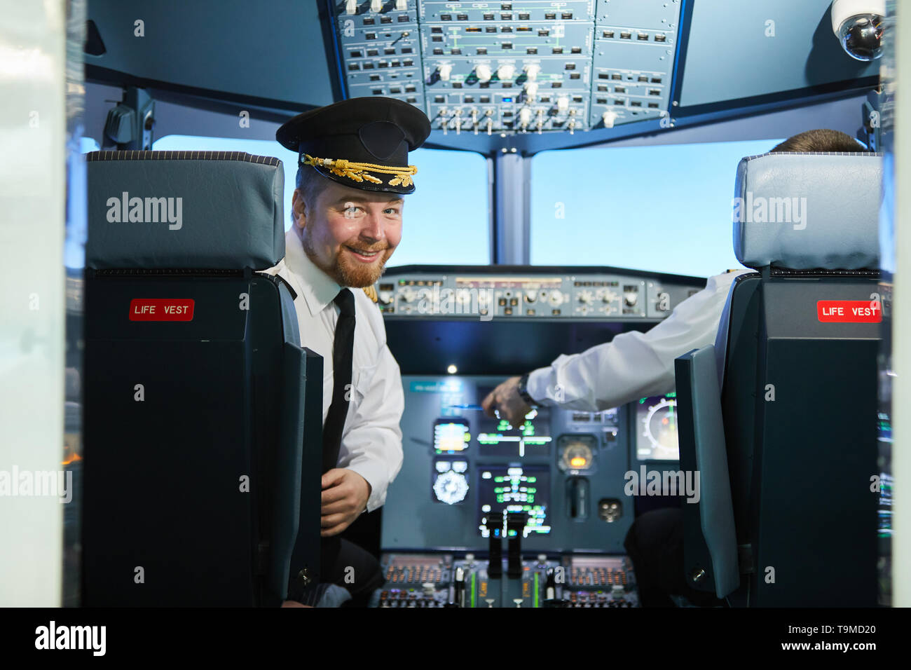 Smiling bearded pilot in cockpit Stock Photo - Alamy